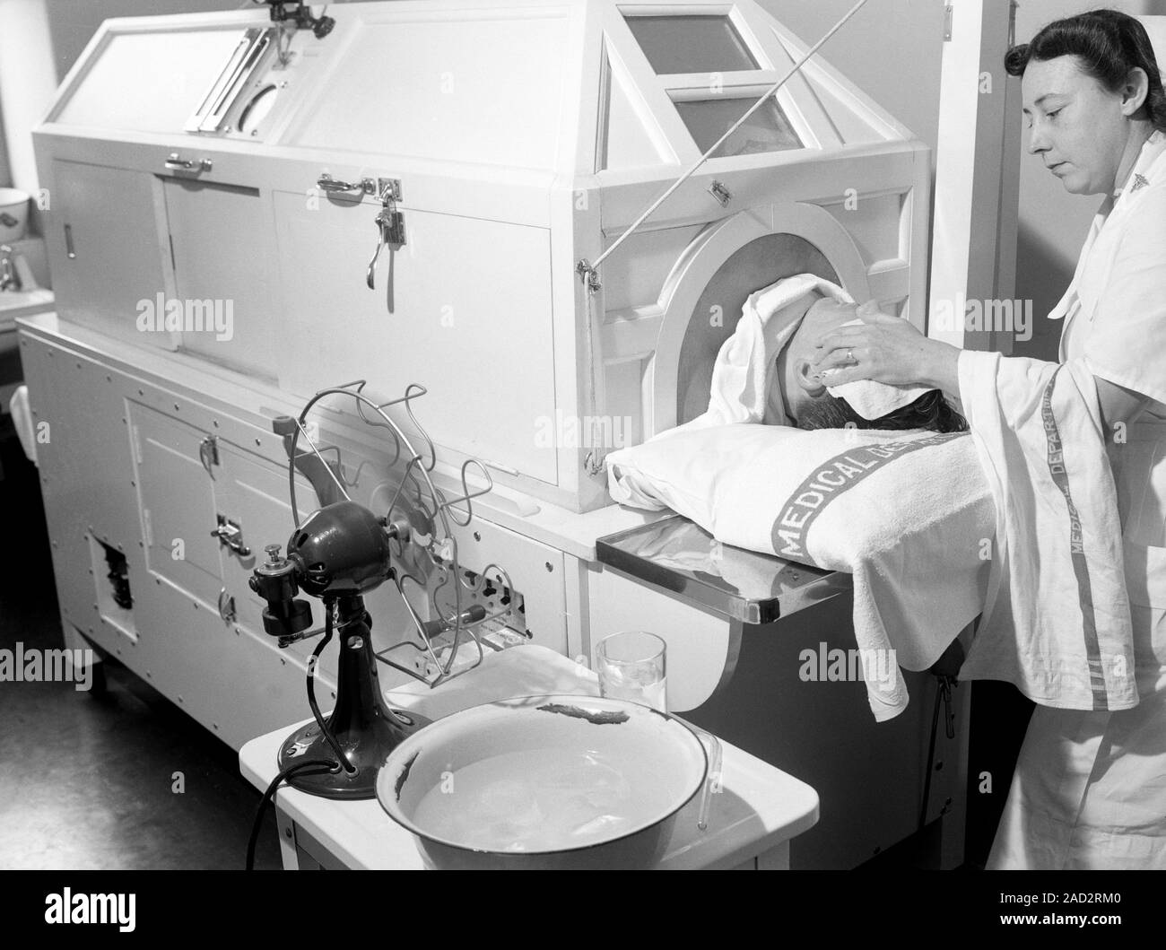 Patient in fever machine. Patient receiving treatment in the 1940s in a ...