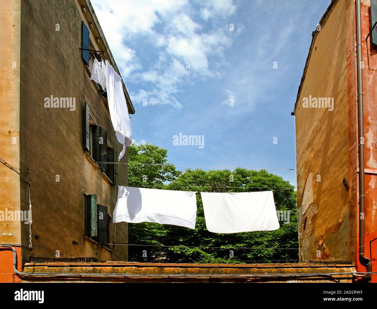 Retro scene of laundry drying on a string between houses Stock Photo ...