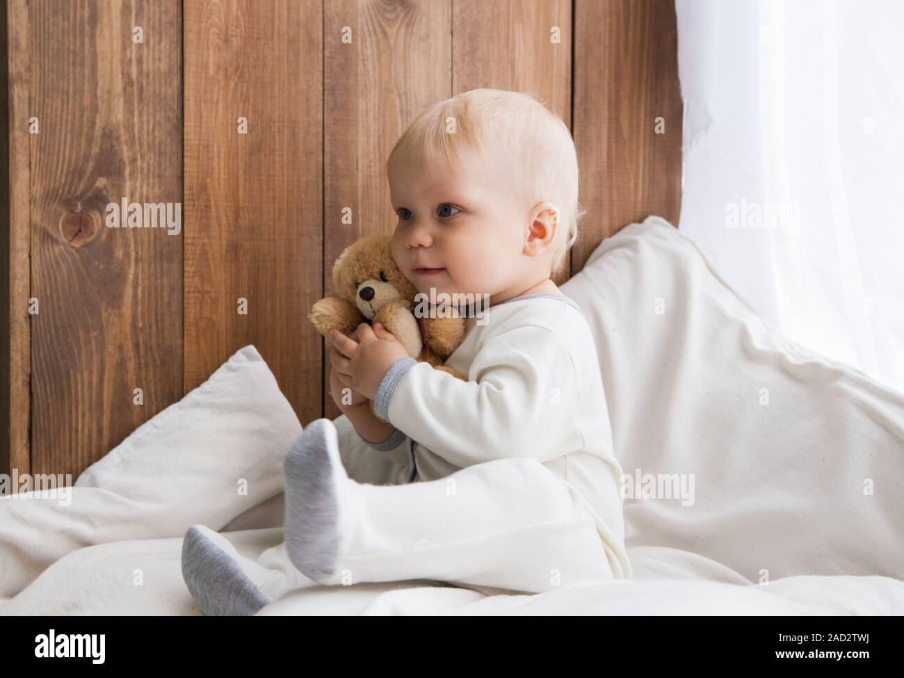 Toddler hugging toy bear Stock Photo - Alamy