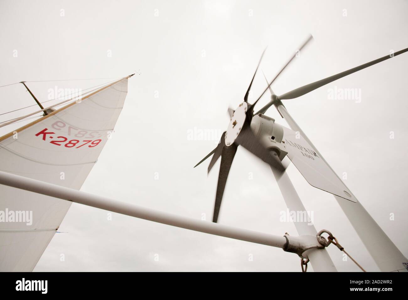 A small scale wind turbine on a sailing boat, sailing past a wind ...