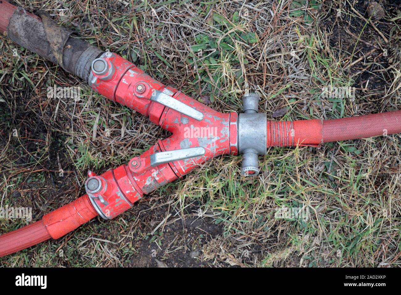 Fire hose with a two-way tap connector. This allows the water supply to ...