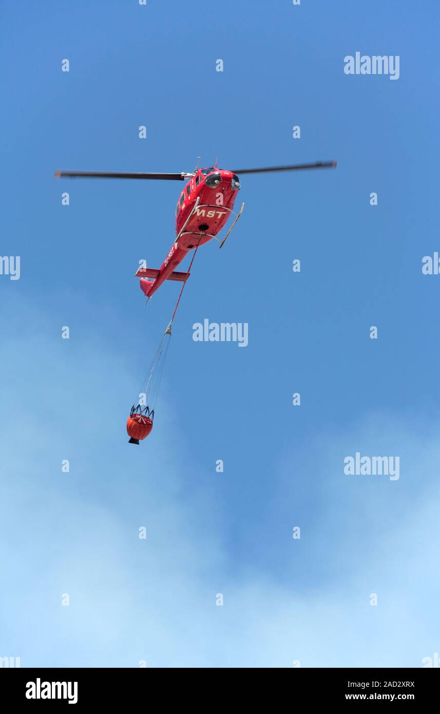 Firefighting helicopter. An emergency aerial firefighting helicopter ...