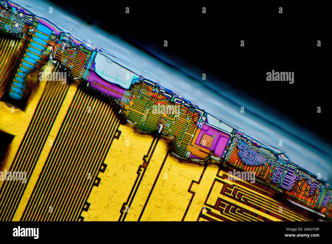Damaged computer RAM module. Light micrograph of a break in the chip of ...