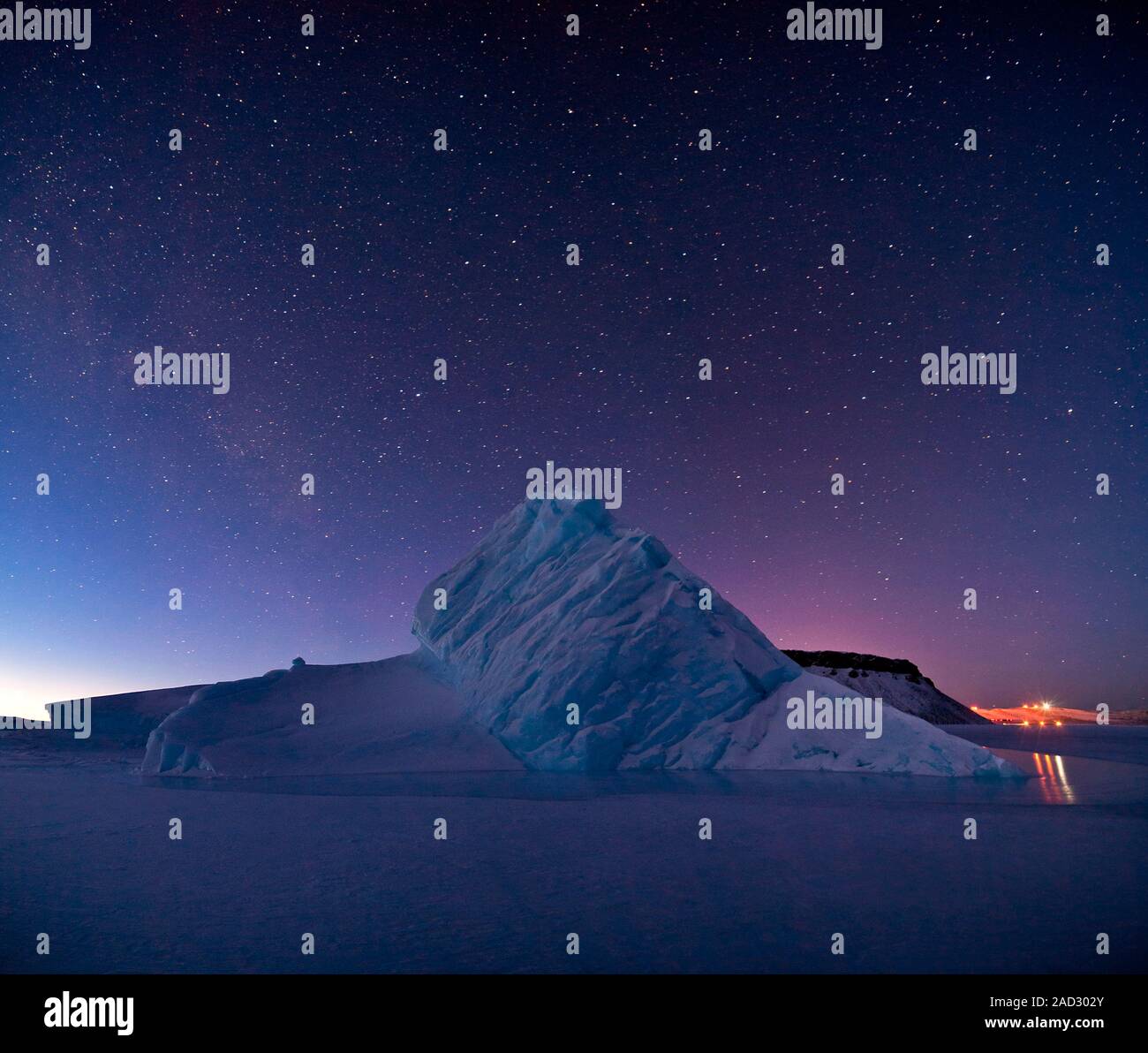Night sky over iceberg. View of stars in the night sky over an iceberg ...