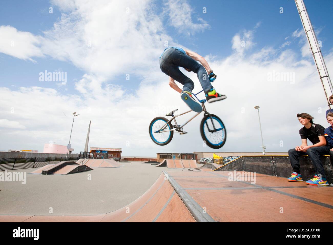 Teenage boys perform aerial stunts on BMX bikes at a BMX park in Rhyl ...