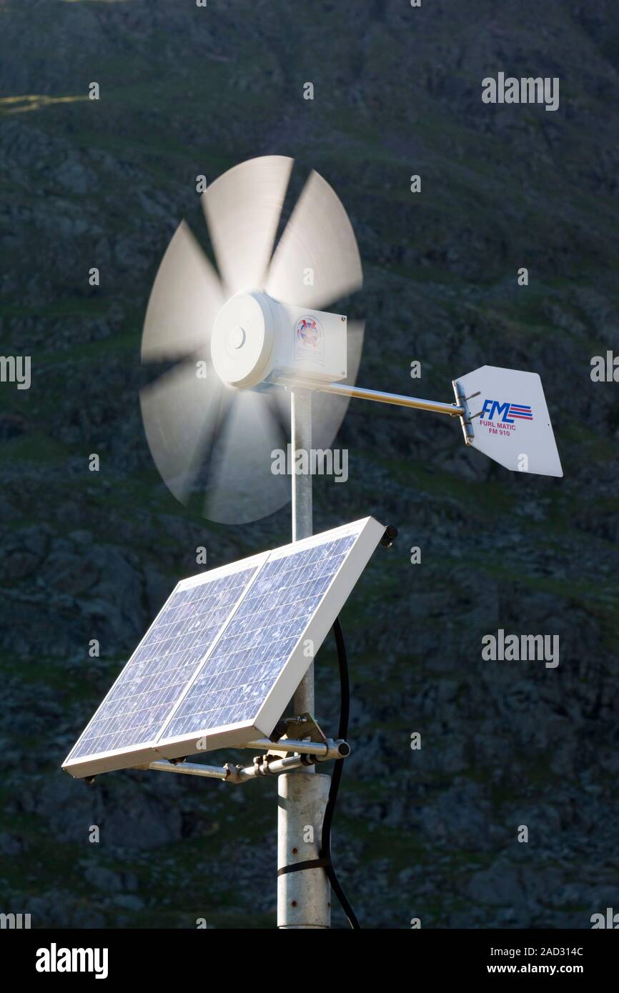A solar electric panel and wind turbine being used to power a neon road ...