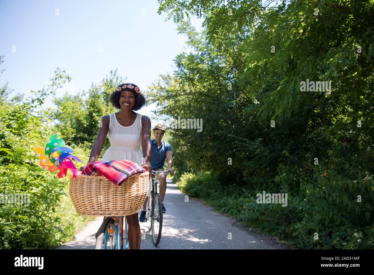 Young couple having joyful bike ride in nature Stock Photo - Alamy