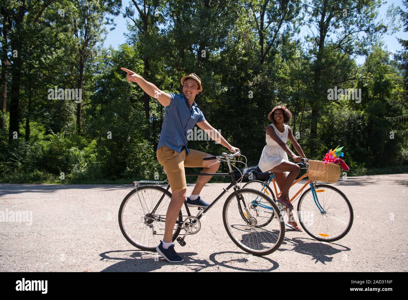 Young couple having joyful bike ride in nature Stock Photo - Alamy