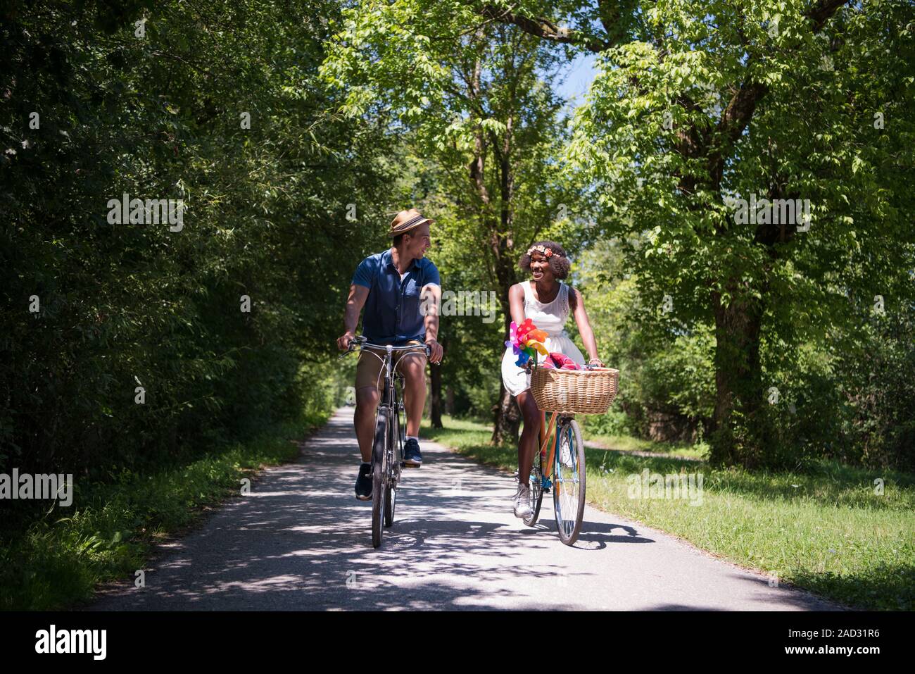 Young couple having joyful bike ride in nature Stock Photo - Alamy