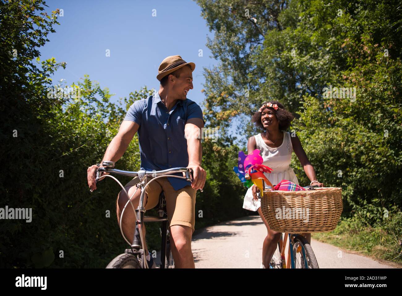 Young couple having joyful bike ride in nature Stock Photo - Alamy