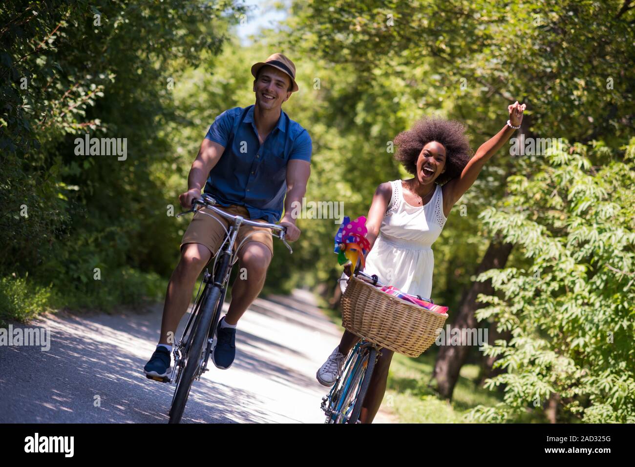 Young couple having joyful bike ride in nature Stock Photo - Alamy