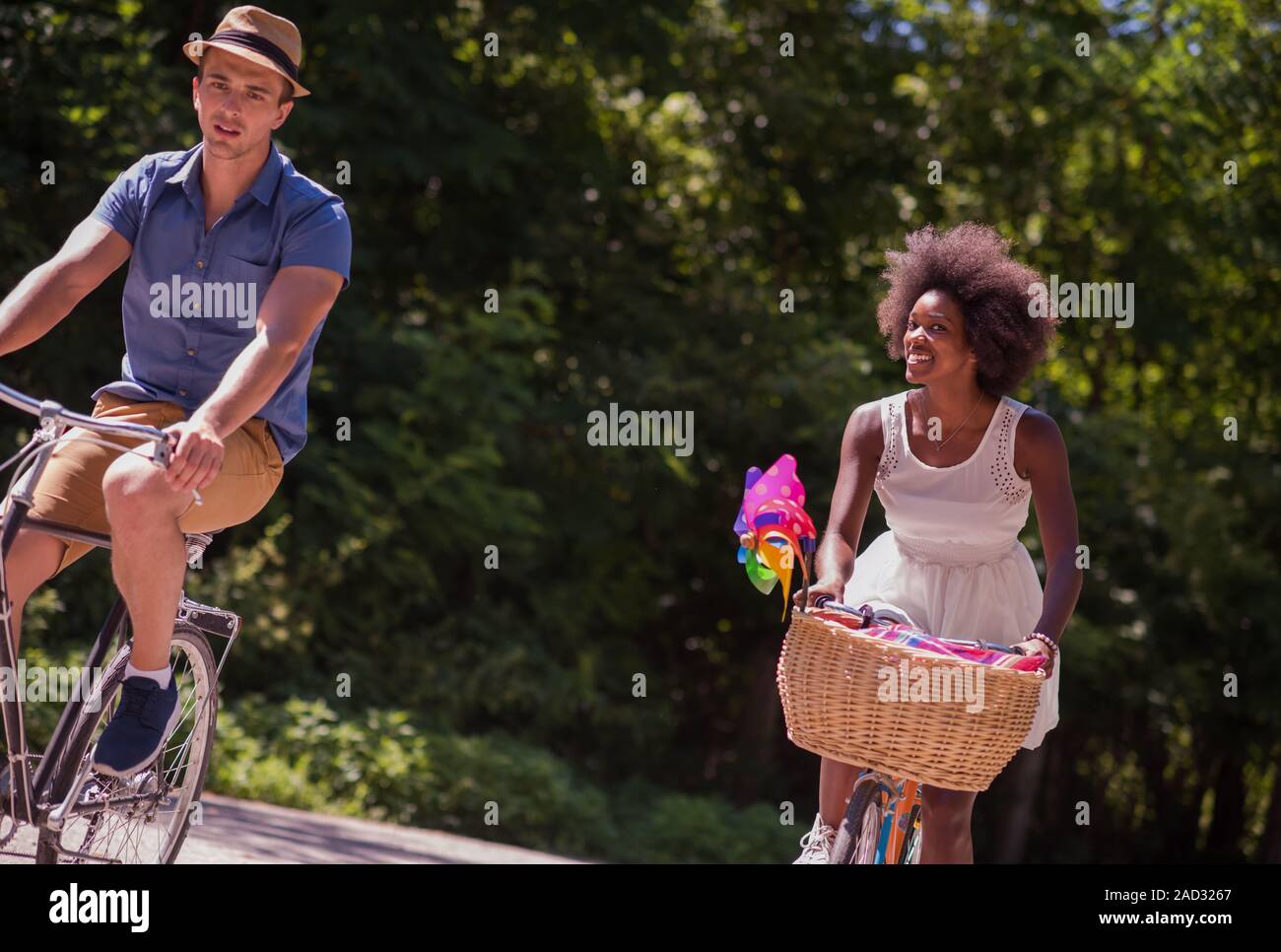 Young couple having joyful bike ride in nature Stock Photo - Alamy