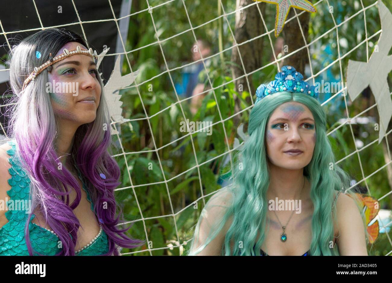 Two girls in costumes of mermaids with dyed hair. Animators at holiday ...