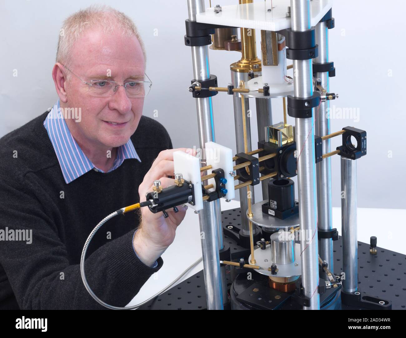 Watt balance. Physicist adjusting a watt balance, an electromechanical ...