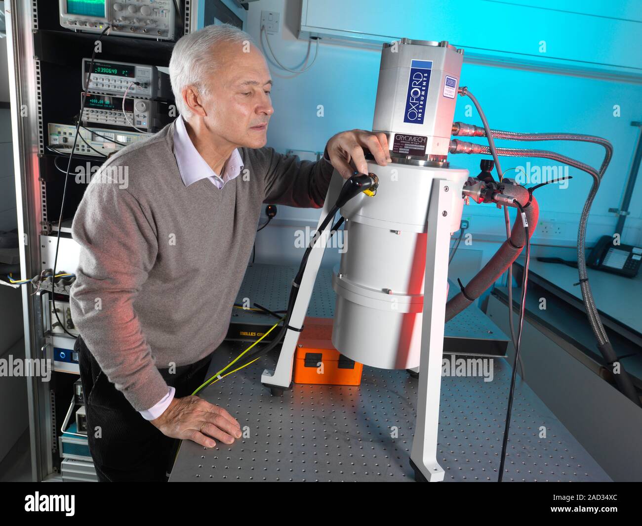 Quantum Hall effect metrology system. Researcher adjusting equipment ...