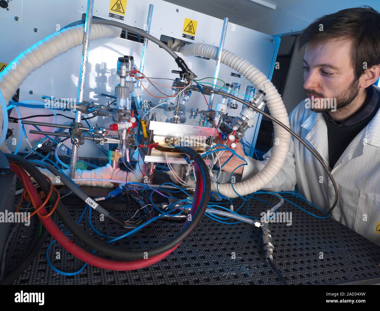 Fuel cell research. Researcher carrying out an experiment to test a ...