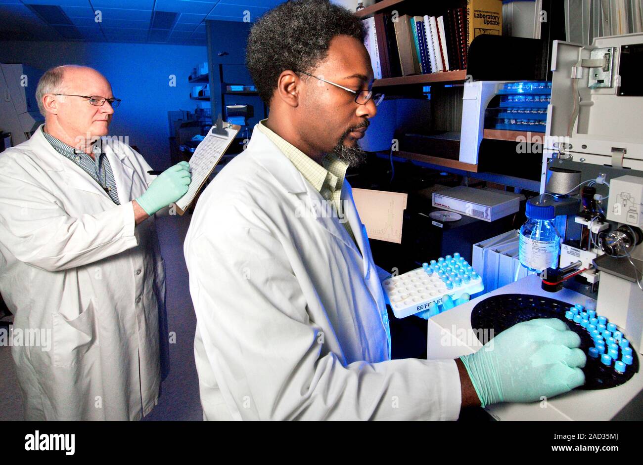 High-performance liquid chromatography. Microbiologists using a high ...