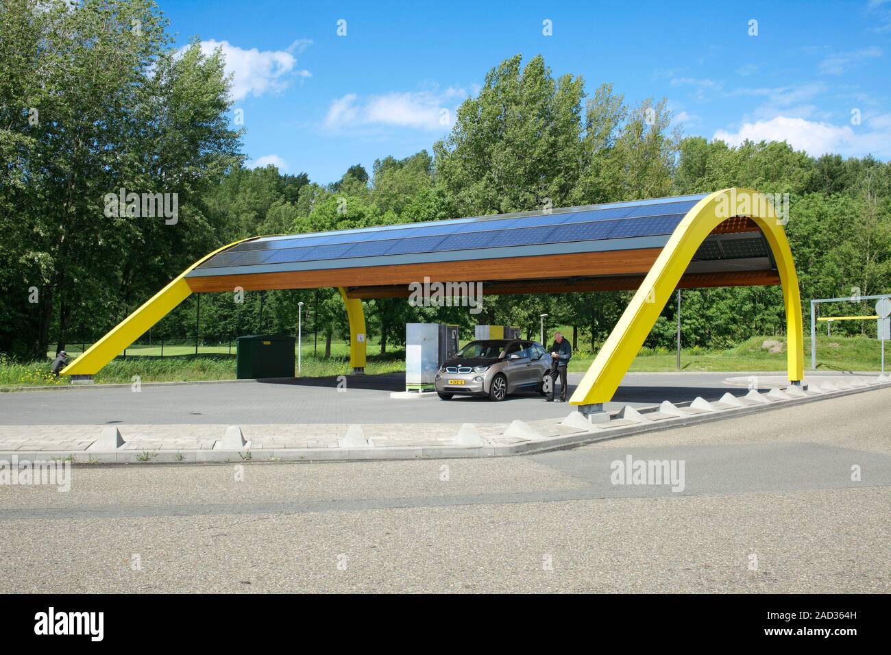Solar-powered car charging station. Electric car being recharged at a ...