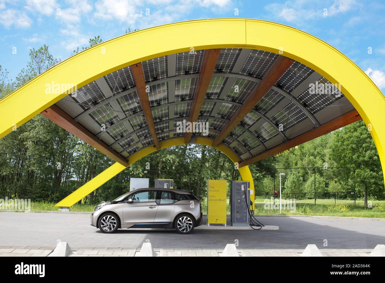 Solar-powered car charging station. Electric car being recharged at a ...