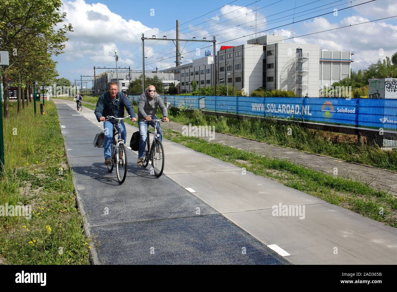 Solar cycle path. People cycling along an experimental section of a ...