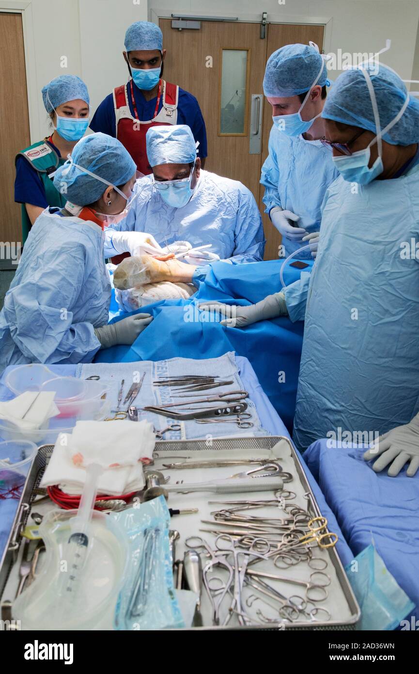 Heel bone surgery. Surgeons and a support team carrying out an ...