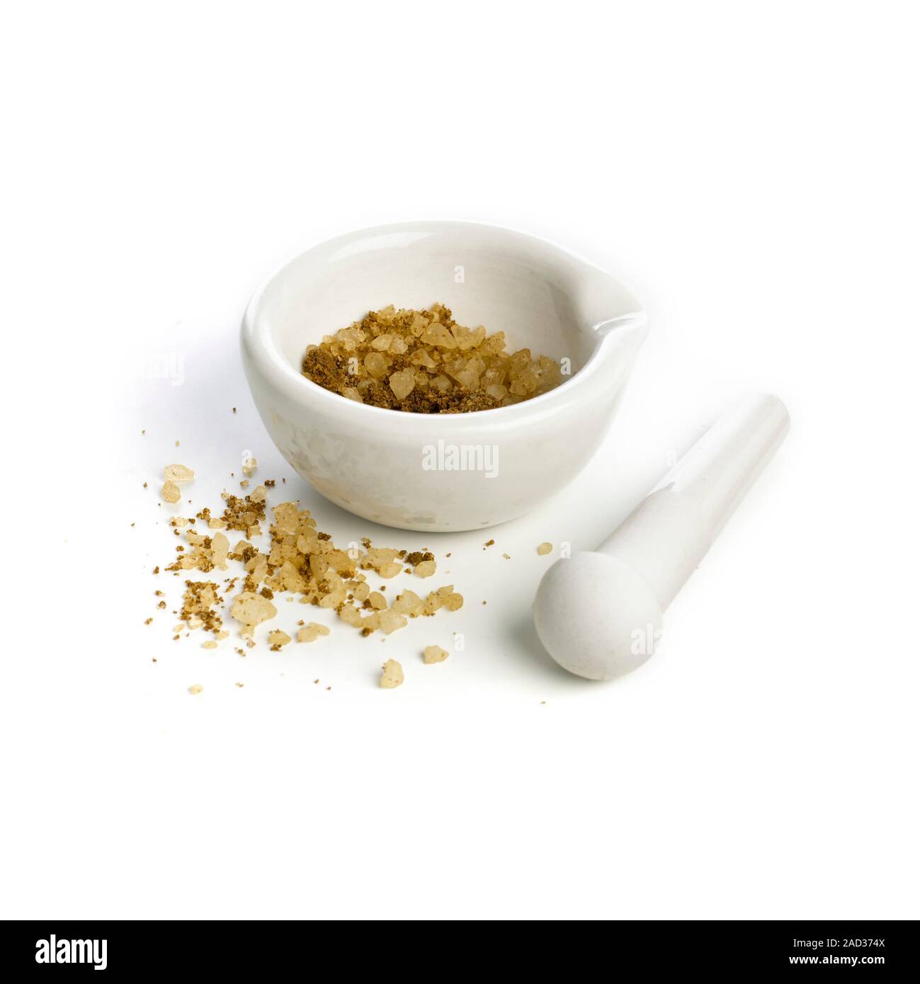 Crystals of natural rock salt in a pestle and mortar. The rock salt has ...