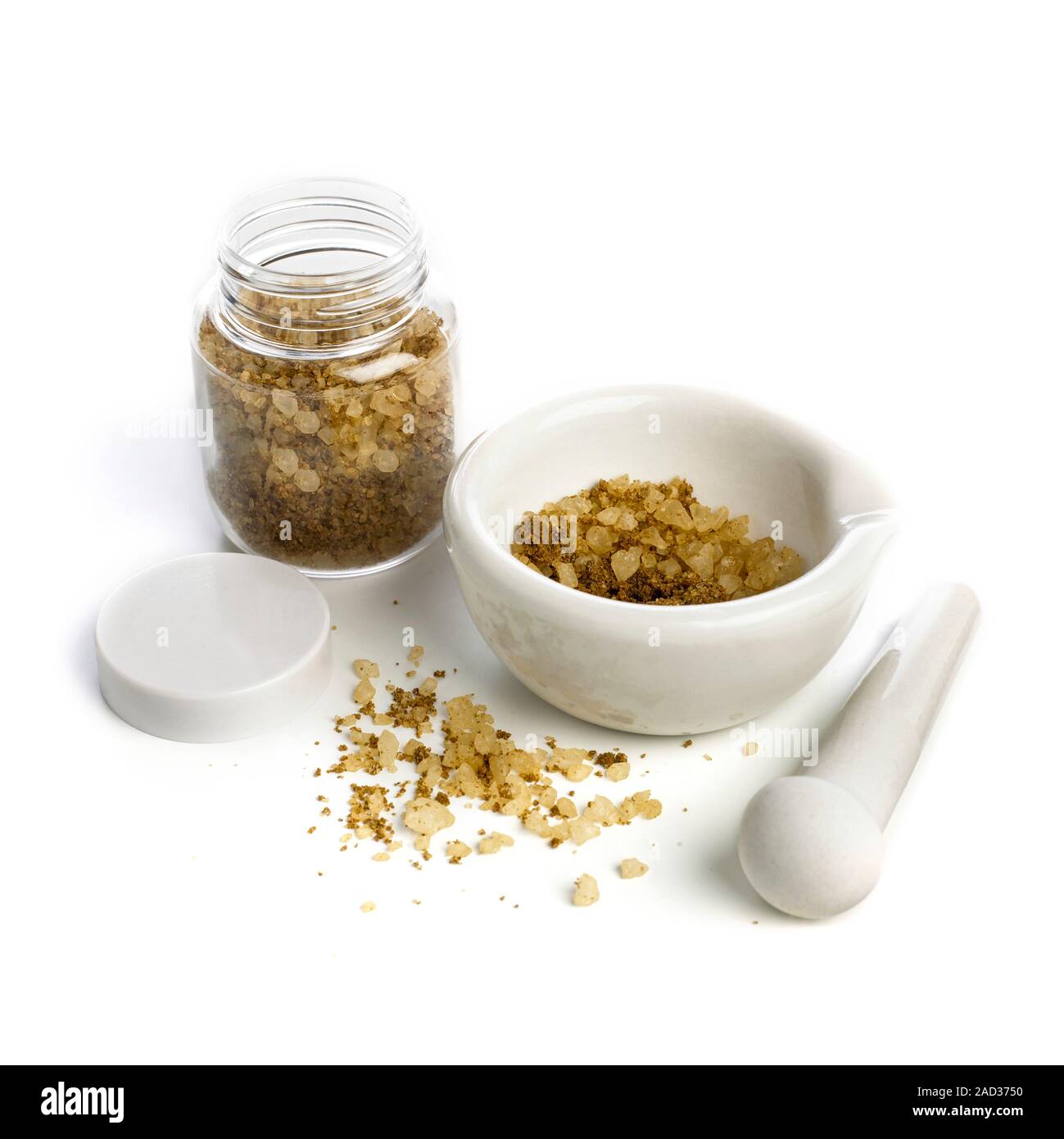 Crystals of natural rock salt in a pestle and mortar. The rock salt has ...