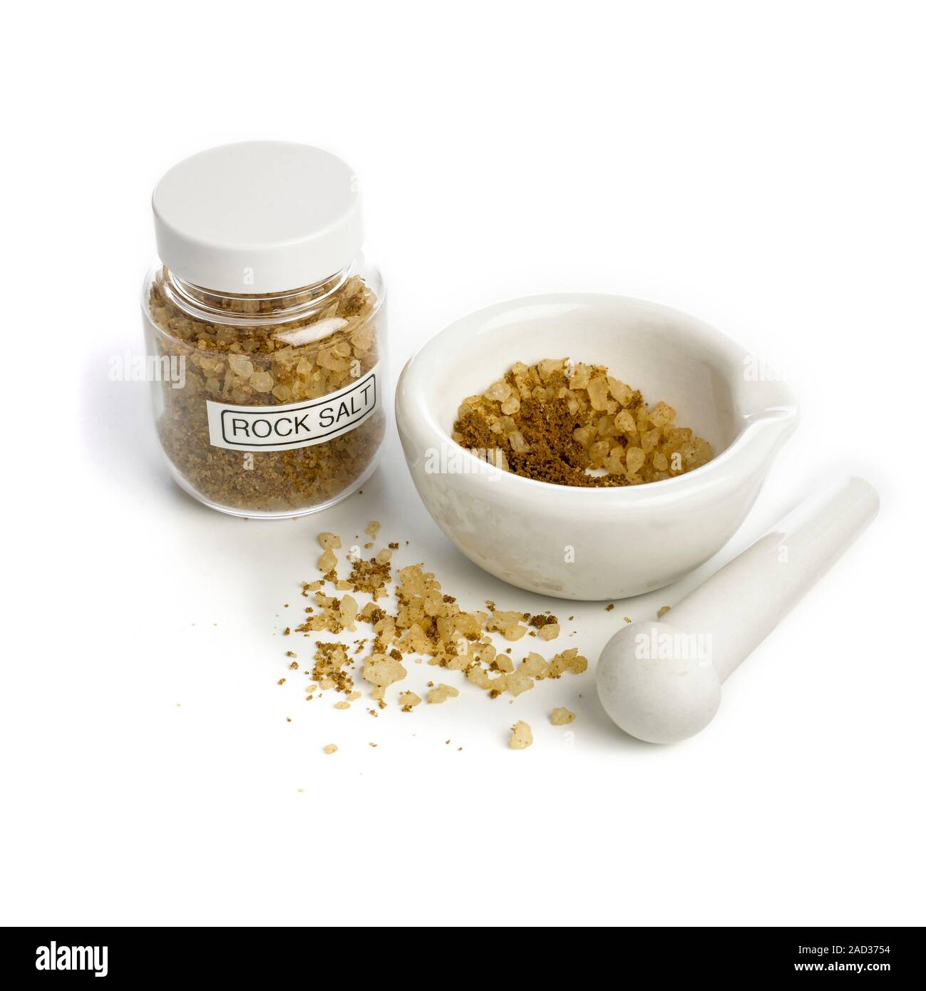 Crystals of natural rock salt in a pestle and mortar. The rock salt has ...