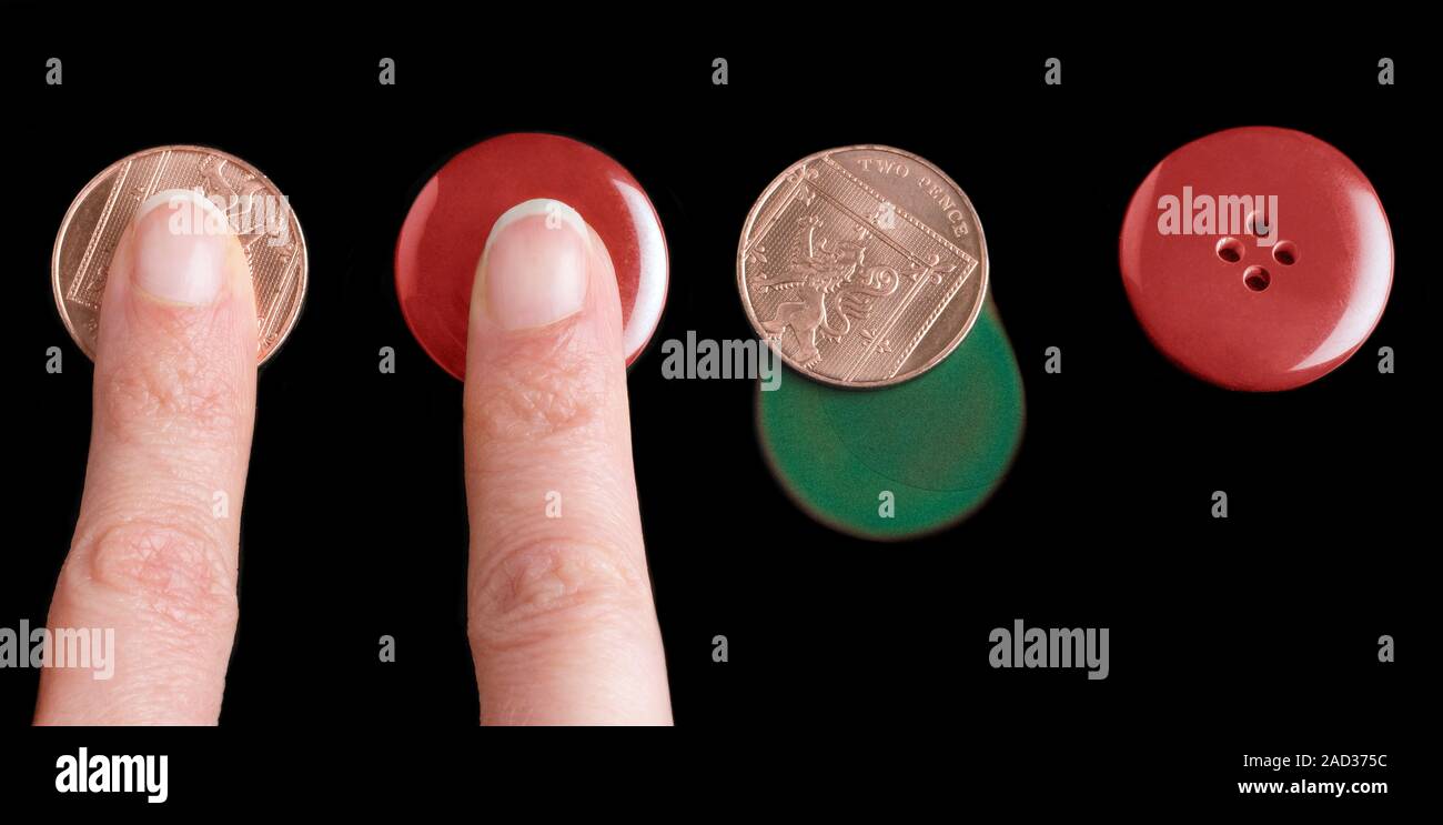 Thermal conduction experiment. A metal coin and a plastic button on ...