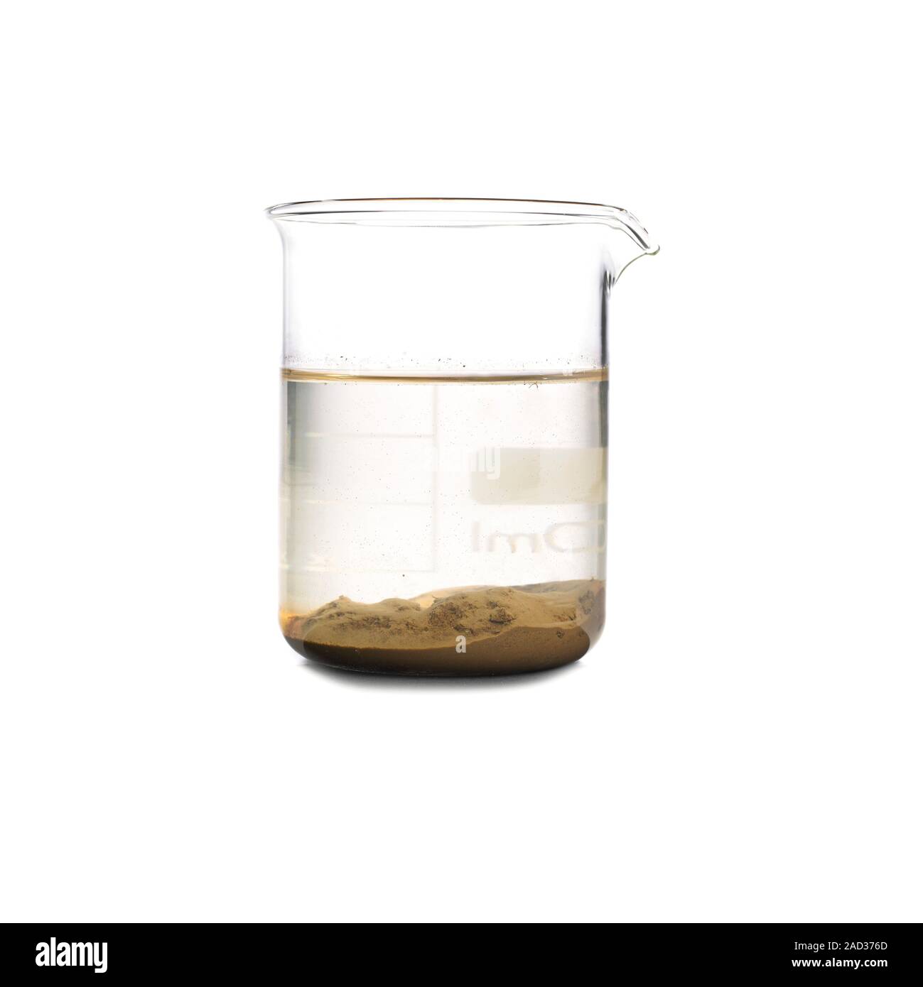 Soil settling out of water . Soil is mixed thoroughly in a beaker of ...