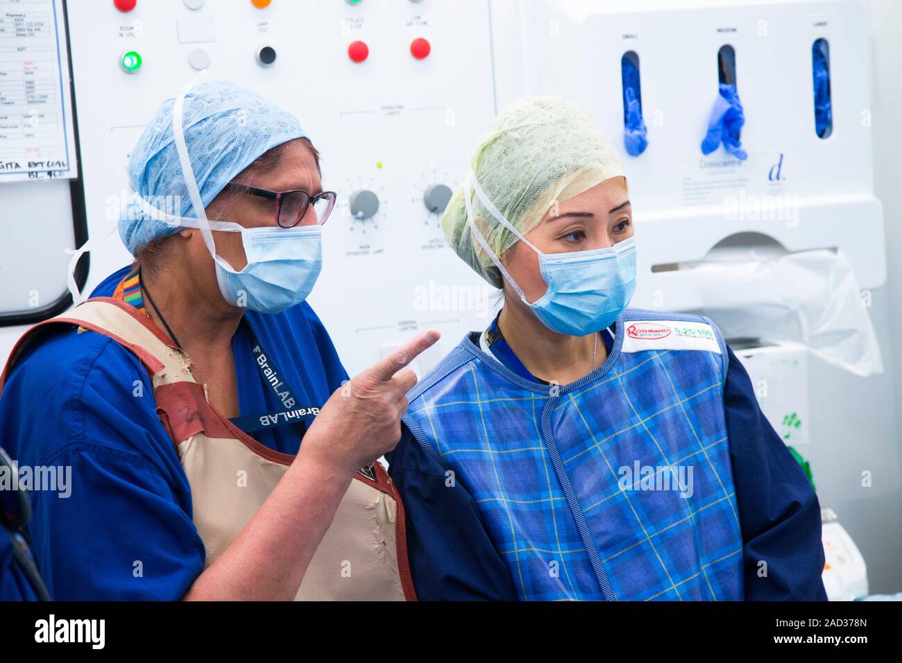 Surgical team members watching an operation. They are wearing lead ...
