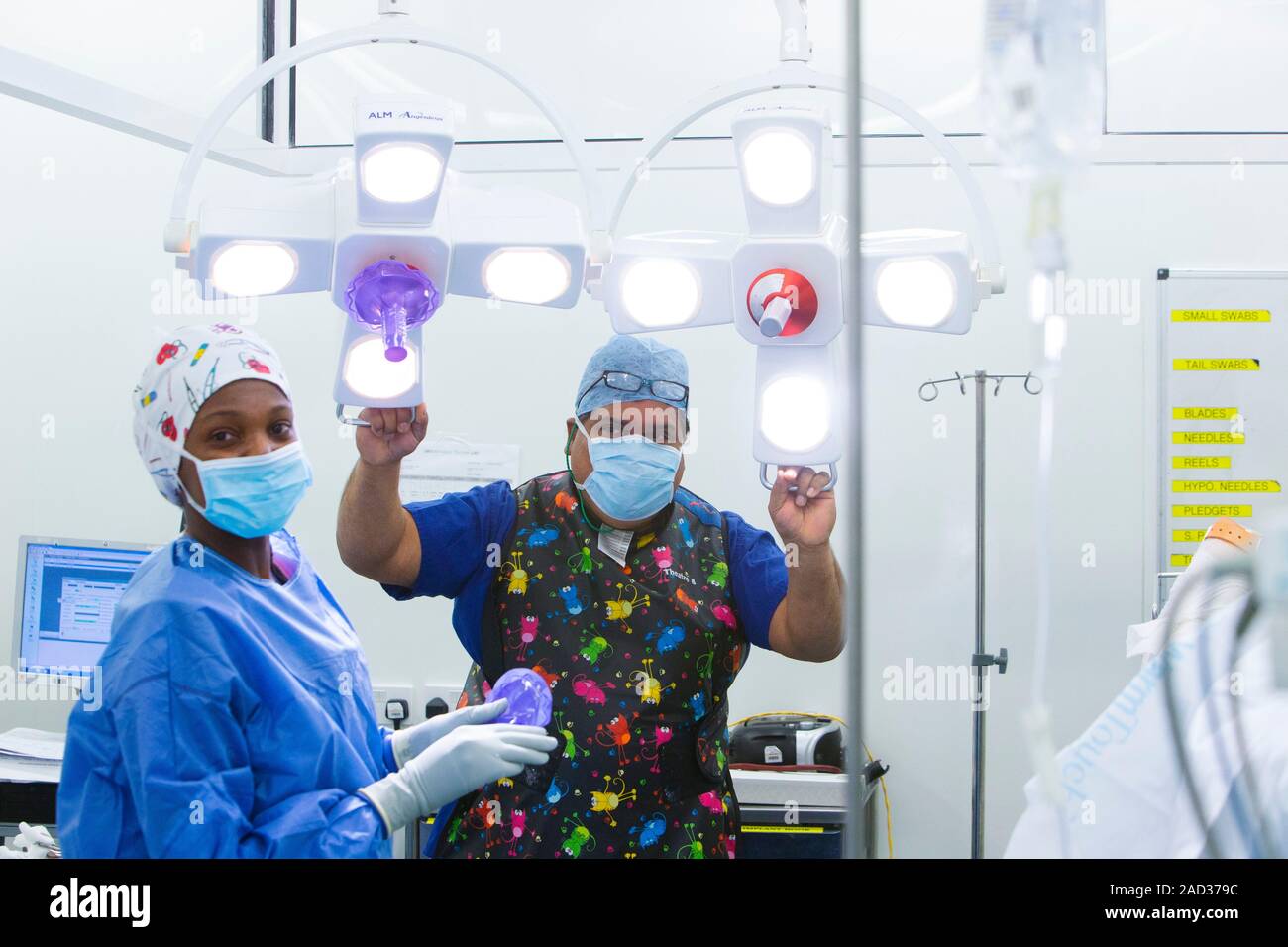 Surgery preparations. Surgical staff in an operating theatre handling ...