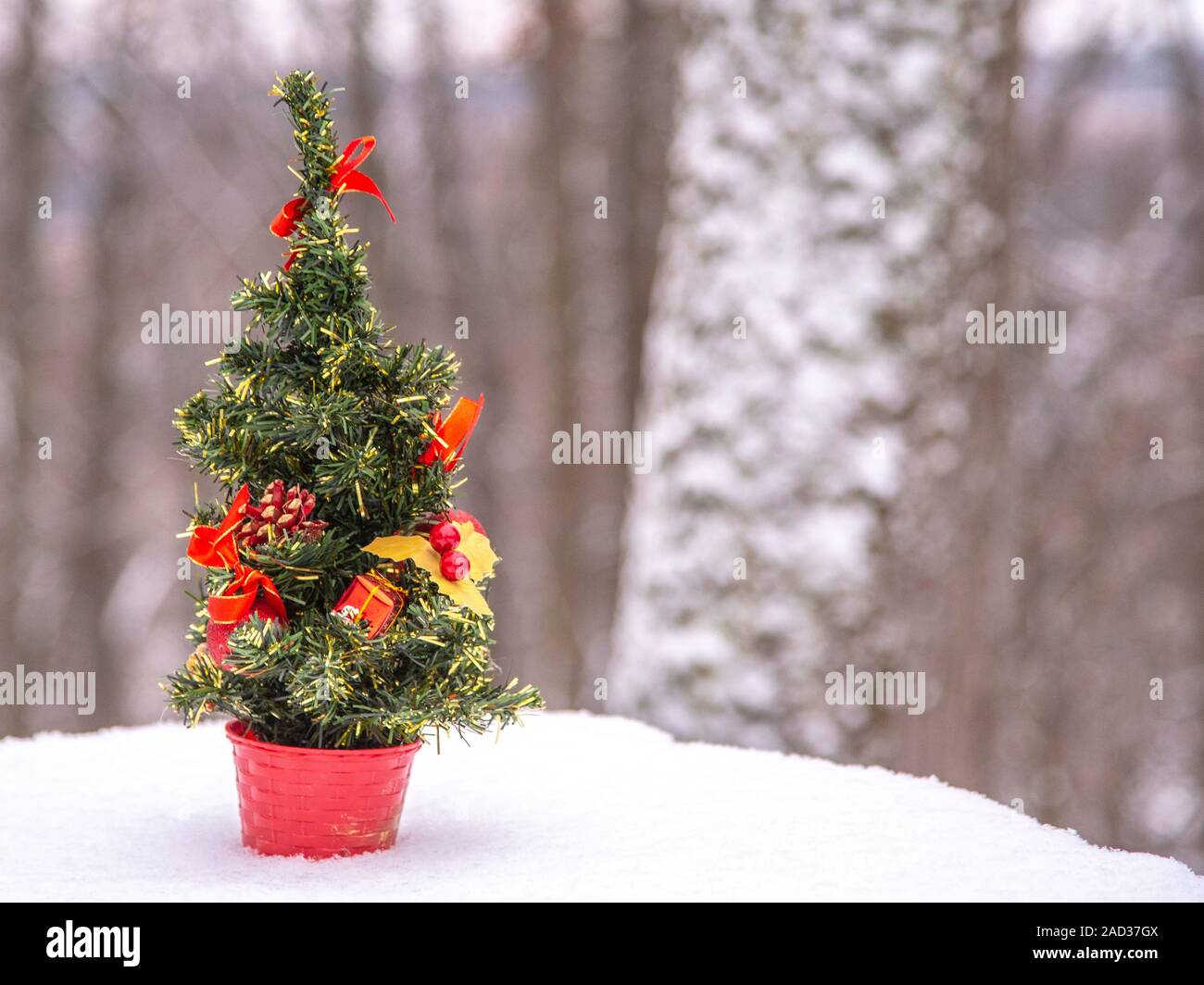 Artificial Christmas tree on a stump in the forest Stock Photo - Alamy