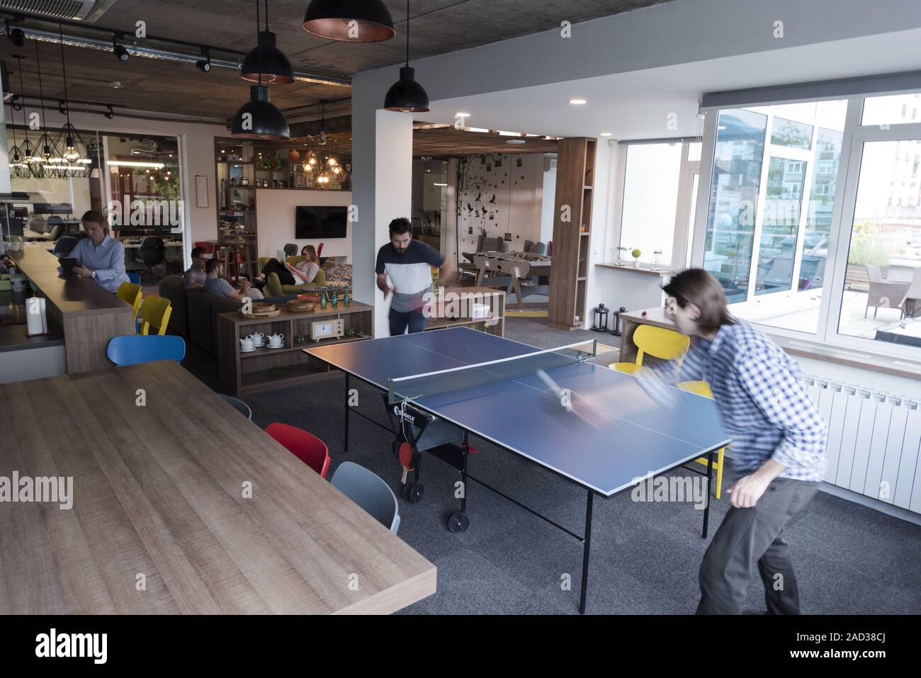 playing ping pong tennis at creative office space Stock Photo - Alamy