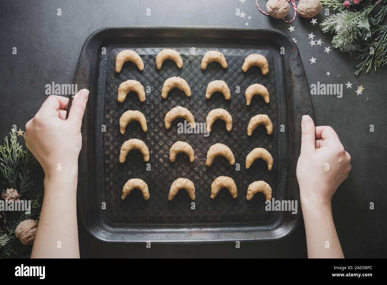 Christmas cookies. Top view of female hands holding baking sheet with ...