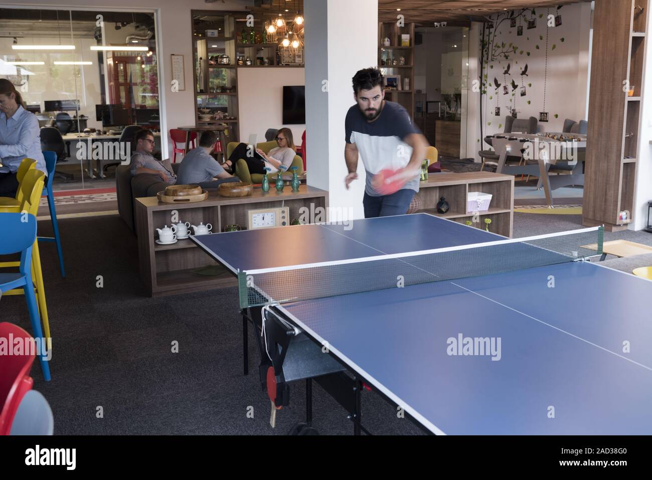 playing ping pong tennis at creative office space Stock Photo - Alamy