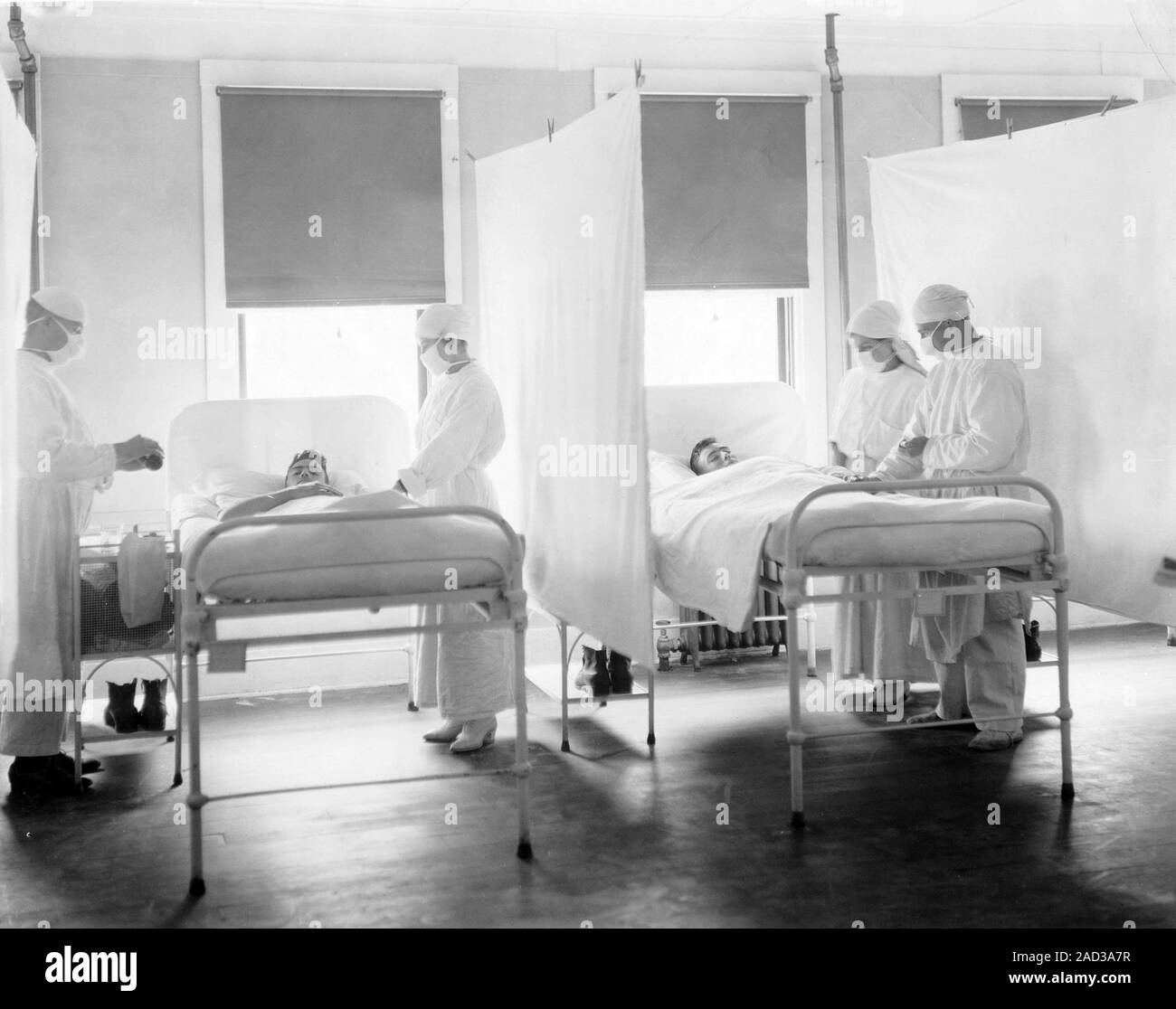 Spanish flu nursing ward. Nurses and doctors with face masks attending ...