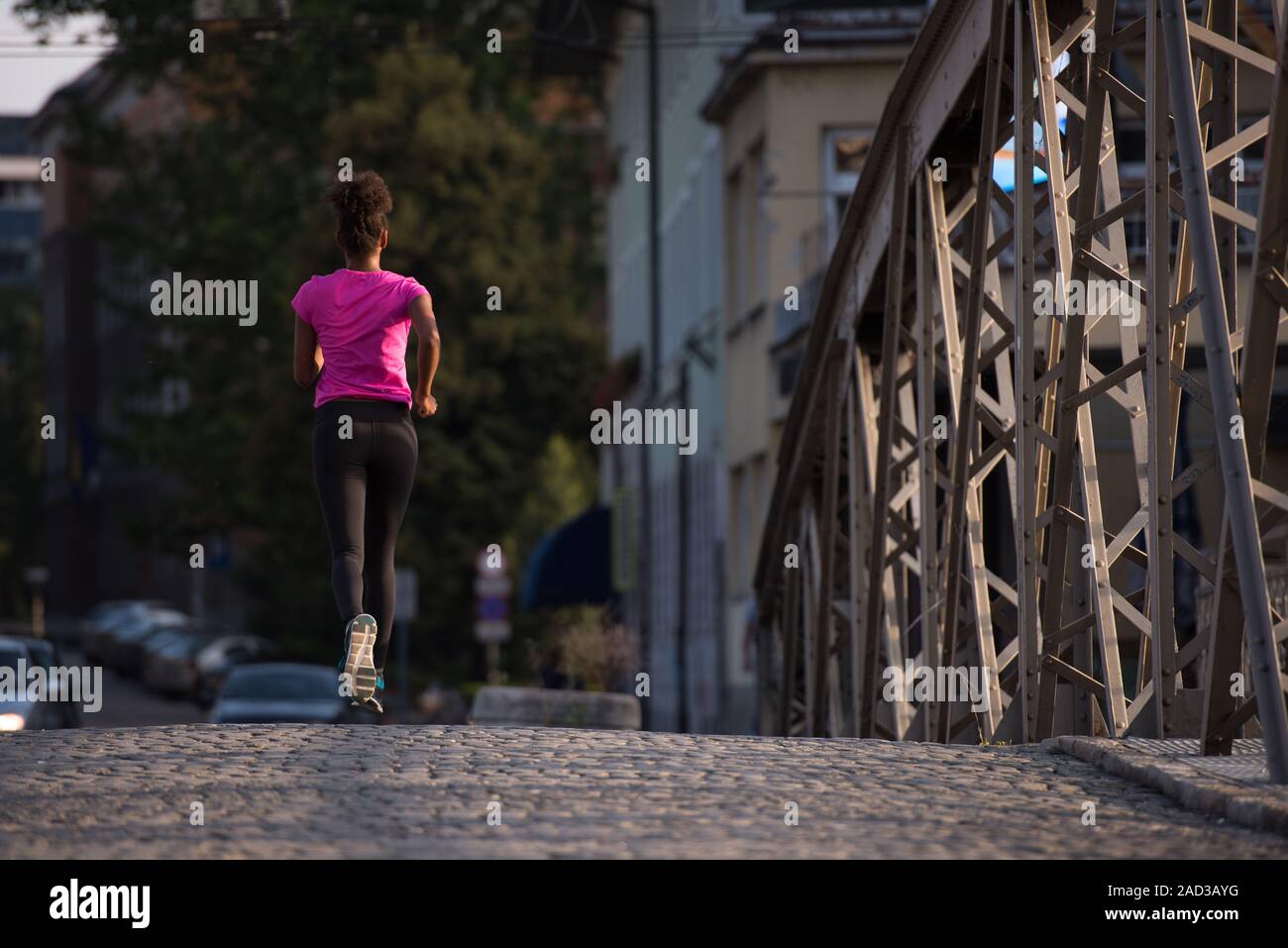 african american woman running across the bridge Stock Photo - Alamy