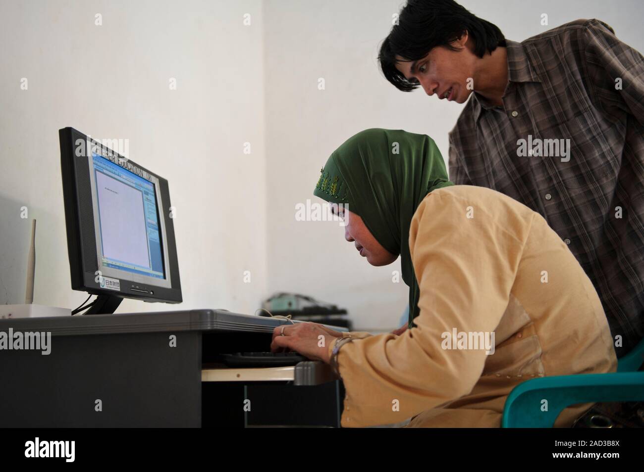 A visually impaired woman learning computer skills. Photographed at ...