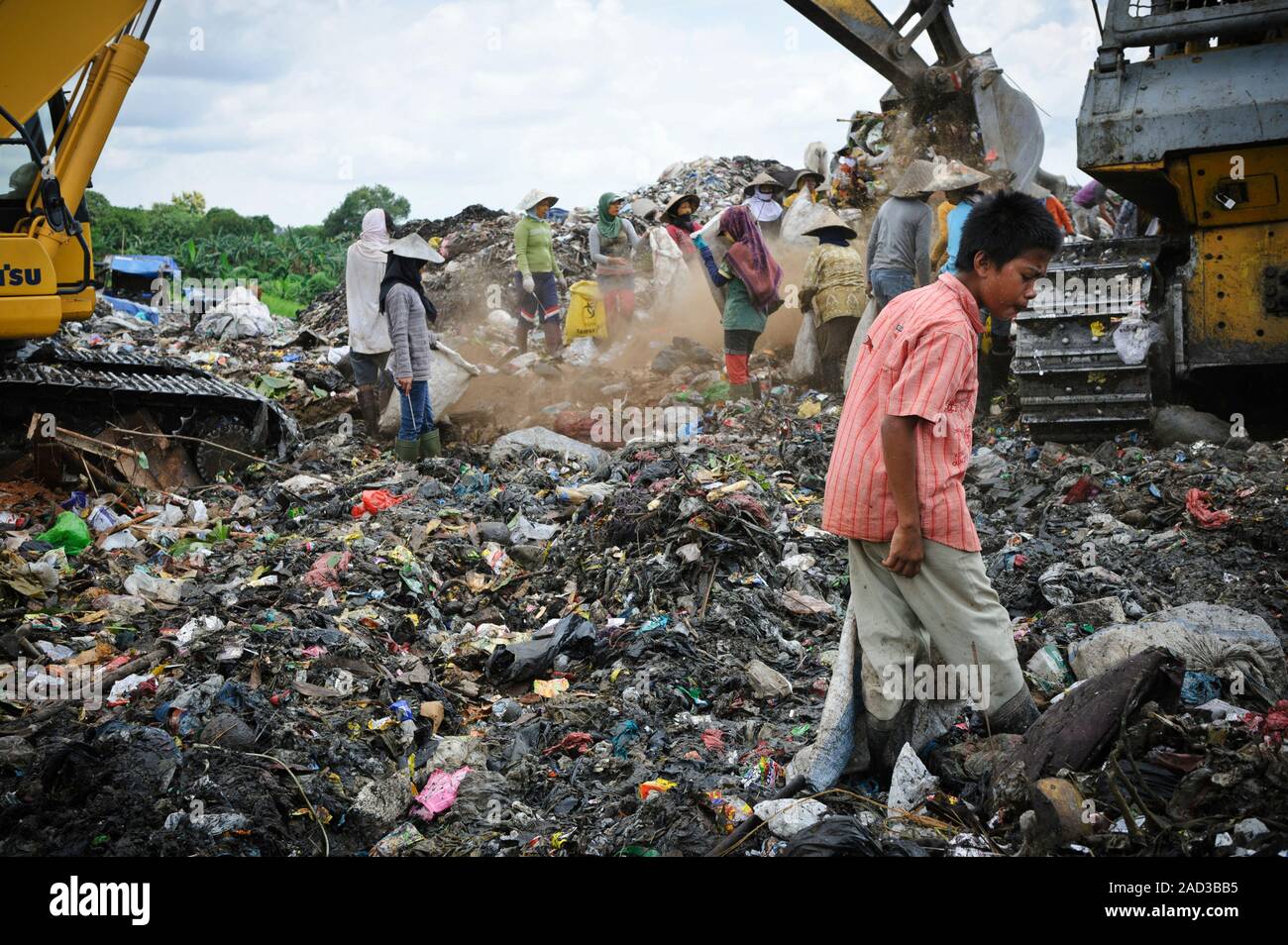 Landfill scavenging. People searching landfill rubbish for food, and ...