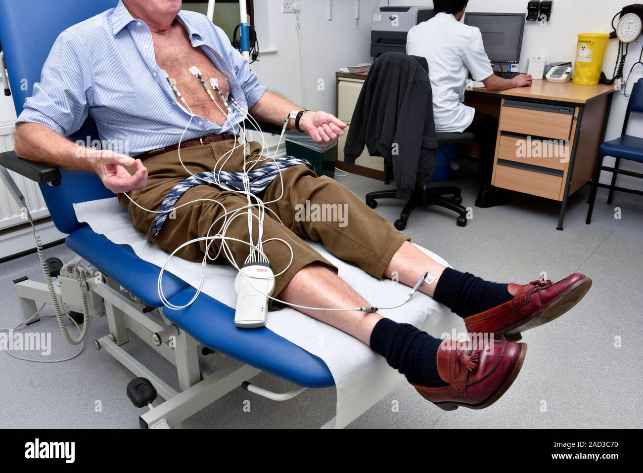 Electrocardiogram. Male patient undergoing an ECG (electrocardiogram ...
