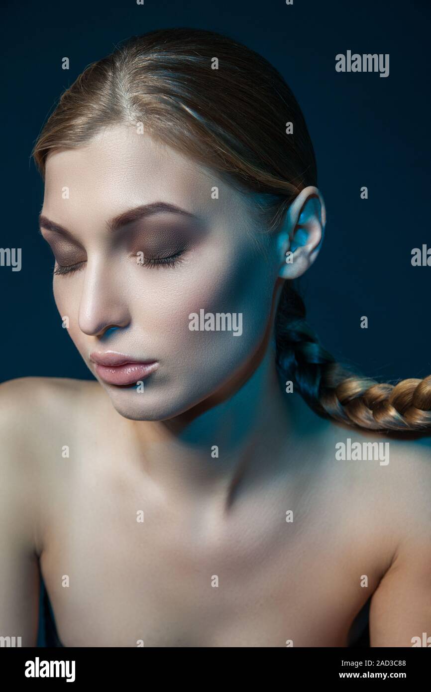 Model with cheek painted in blue Stock Photo - Alamy