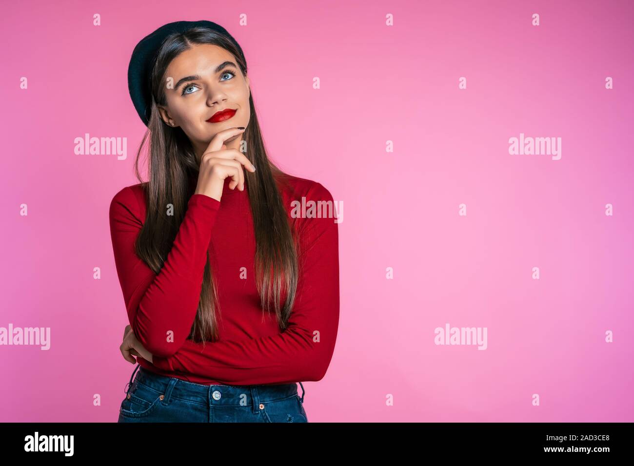 Serious girl in red wear. Portrait of young thinking pondering pretty ...
