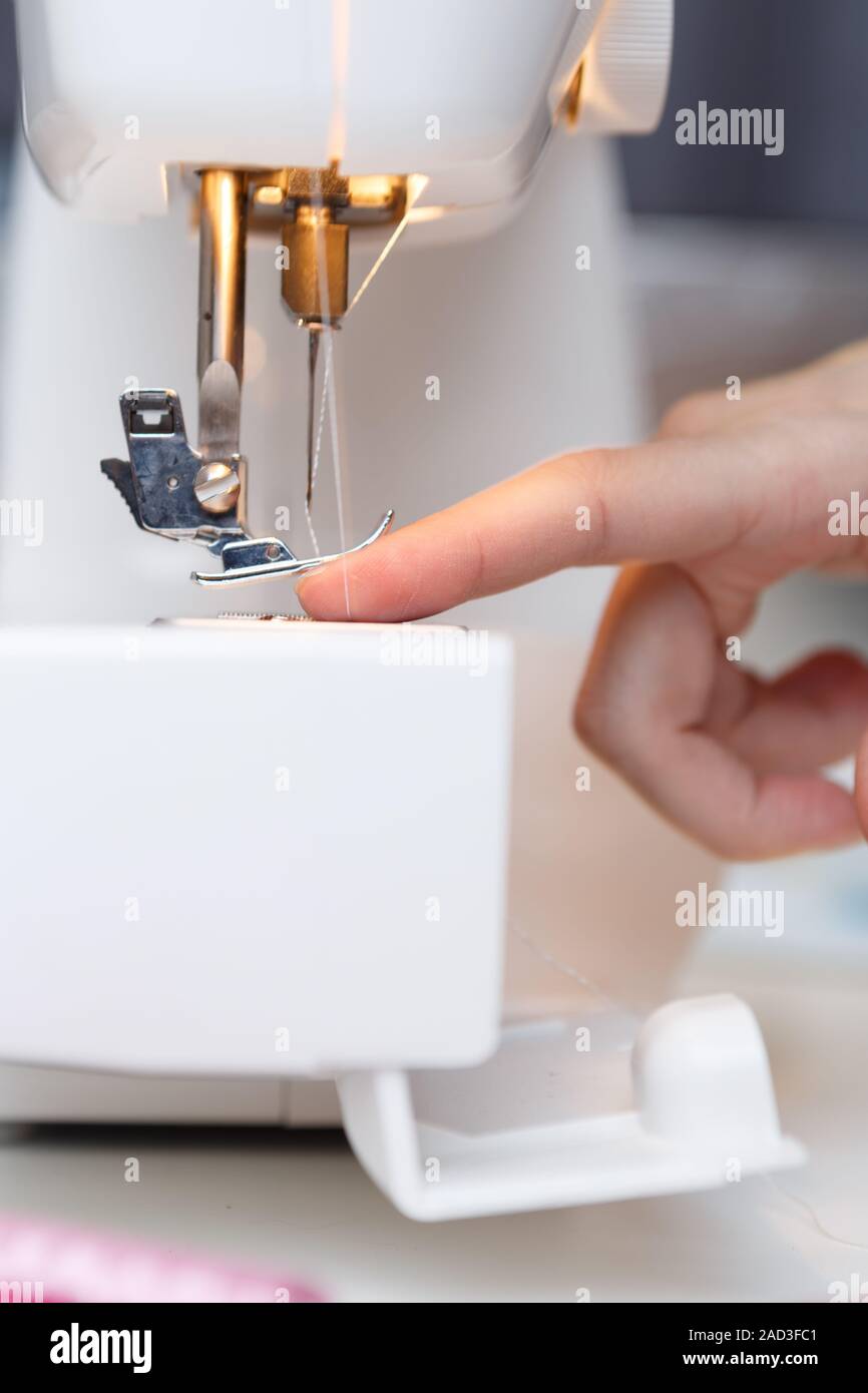 Seamstress put thread in needle Stock Photo - Alamy