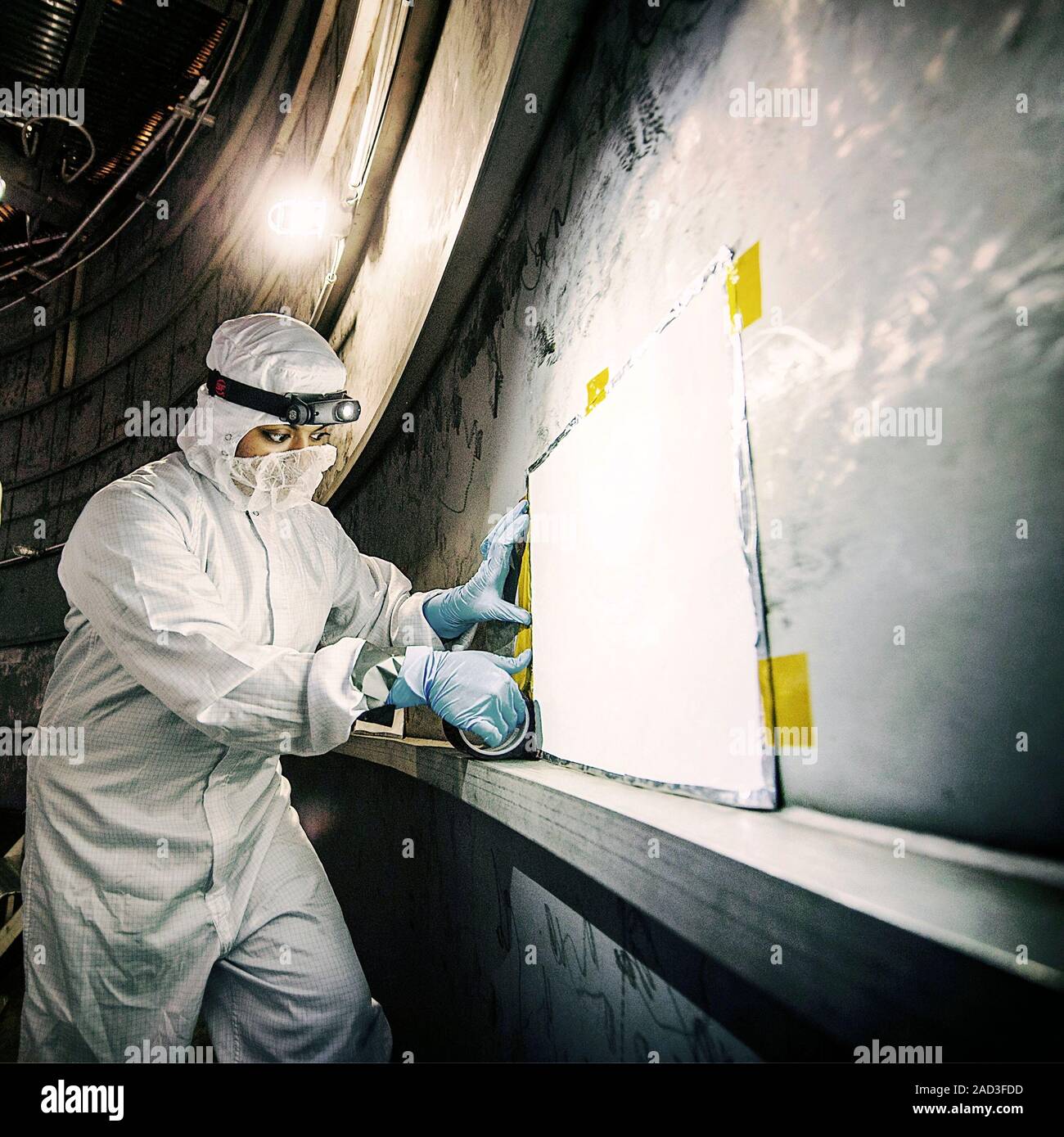 Aerospace test area decontamination. Thermal coatings engineer placing ...