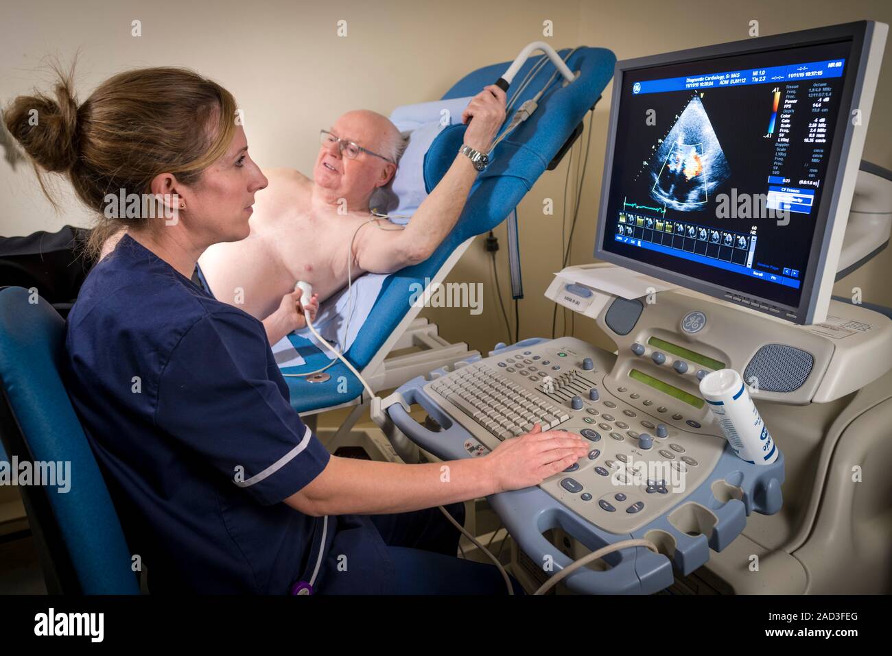 Doppler echocardiography test. Nurse using an ultrasound scanner to ...