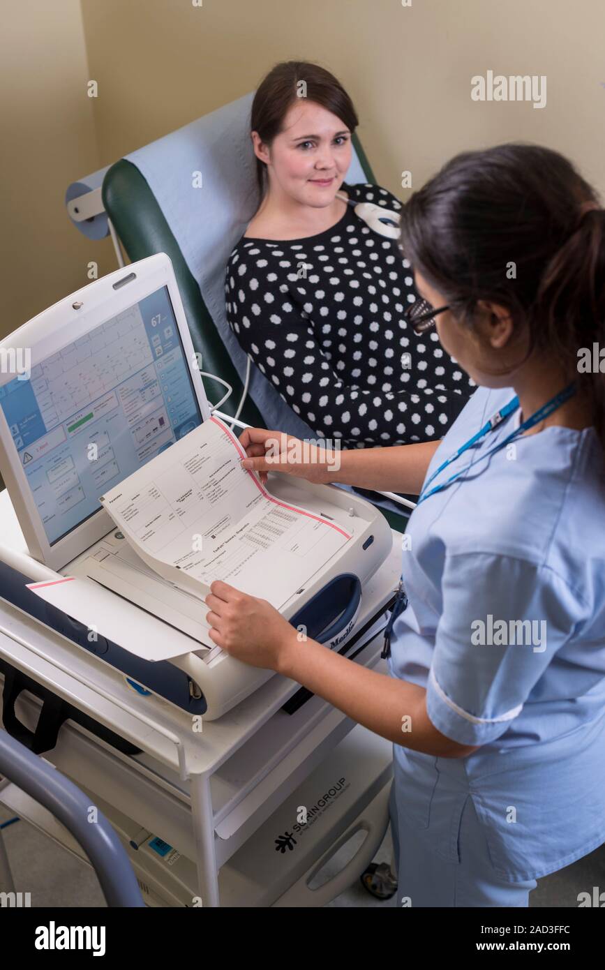 Pacemaker tests. Nurse in a hospital's cardiology department carrying ...