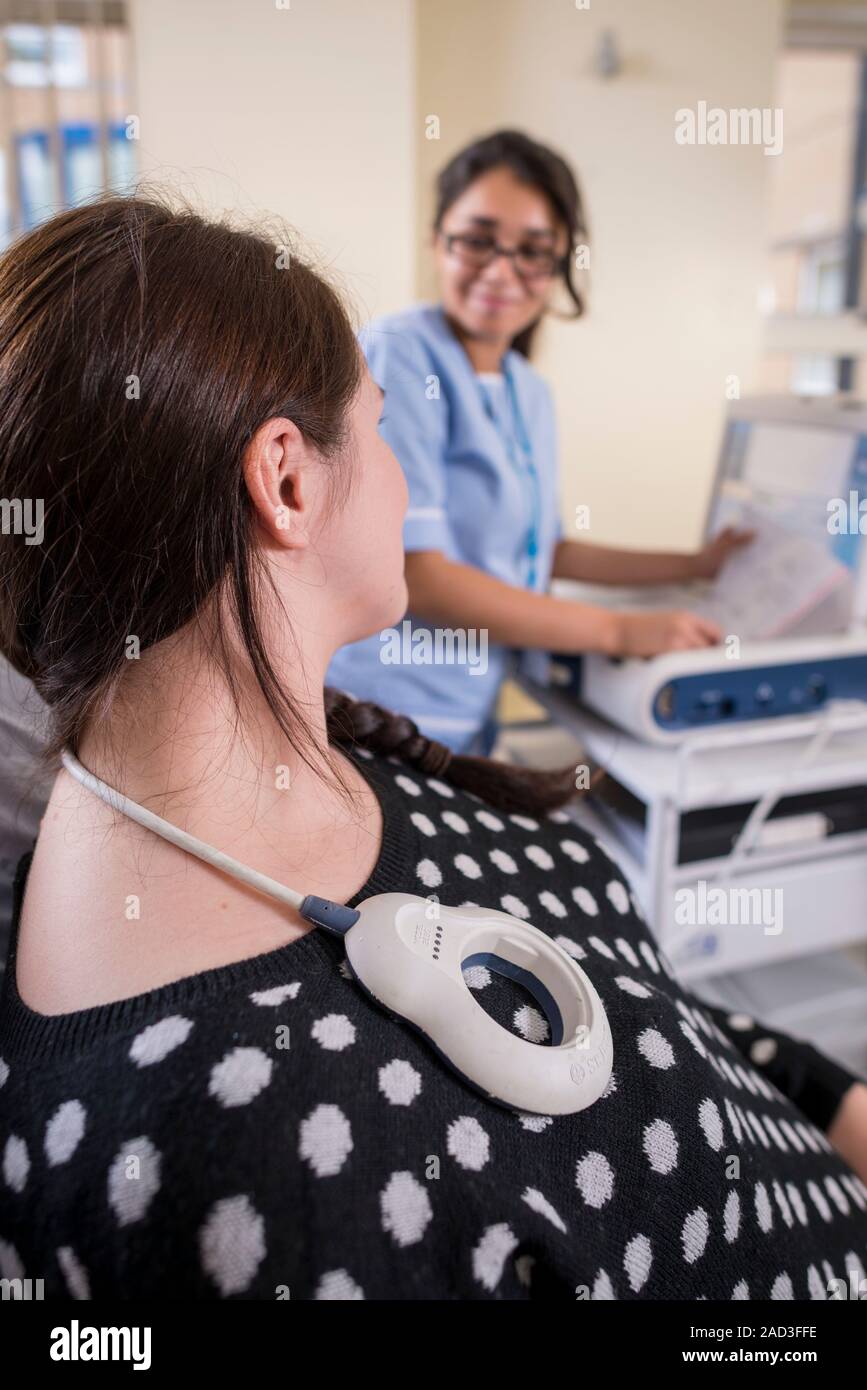 Pacemaker tests. Nurse in a hospital's cardiology department carrying ...