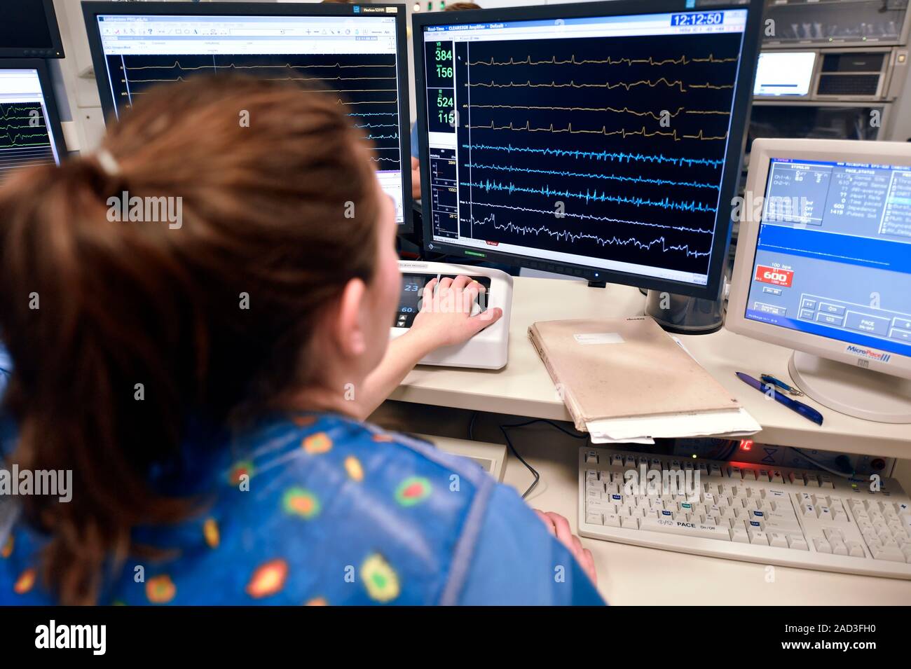 Heart surgery electrophysiology monitor. Member of a surgical team ...