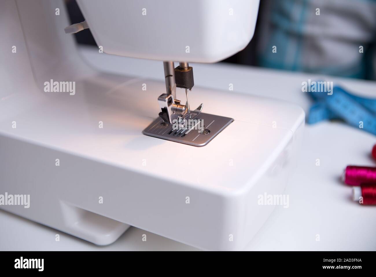 Sewing-machine on table with coils Stock Photo - Alamy